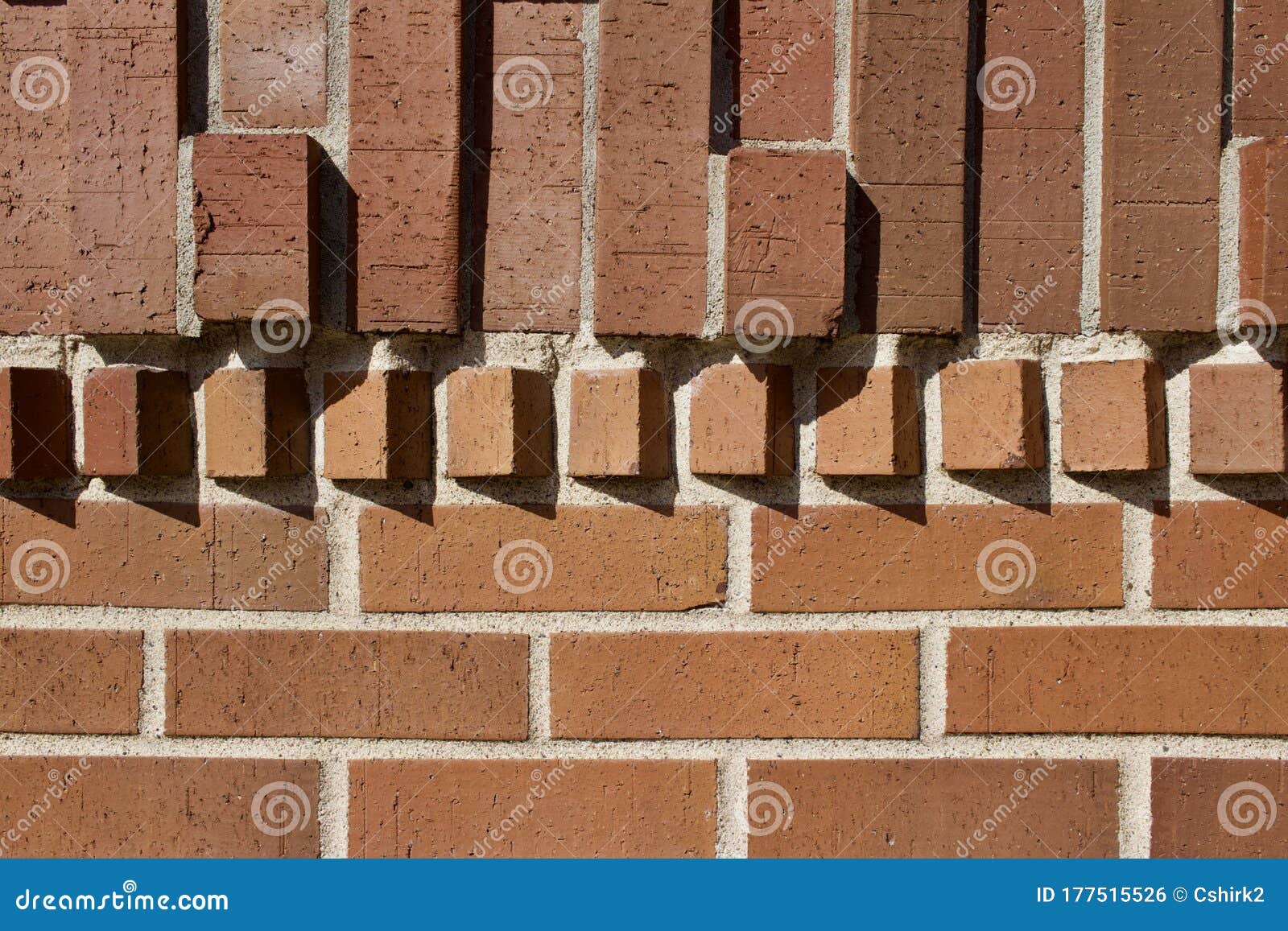 Brown Brick Wall Texture Background with Header of Protruding Bricks in ...