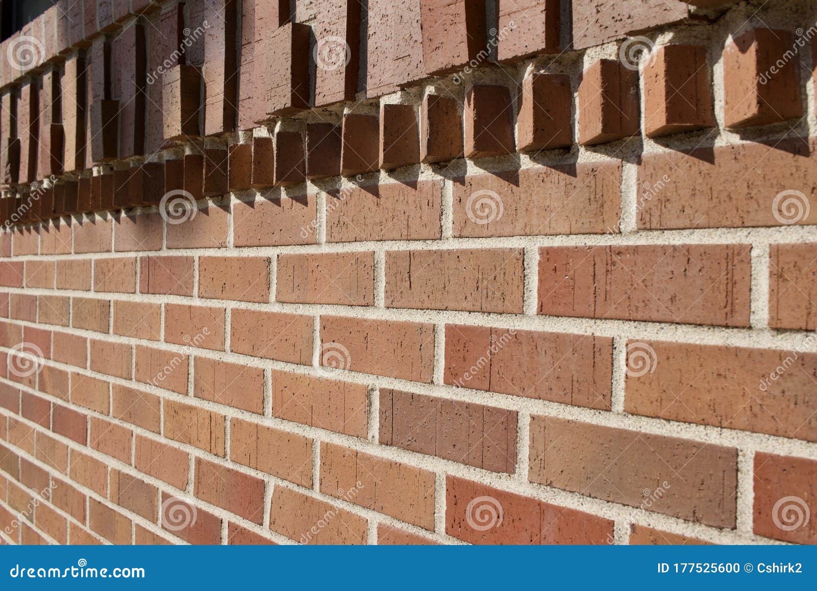 Brown Brick Wall Texture Background with Header of Protruding Bricks in ...