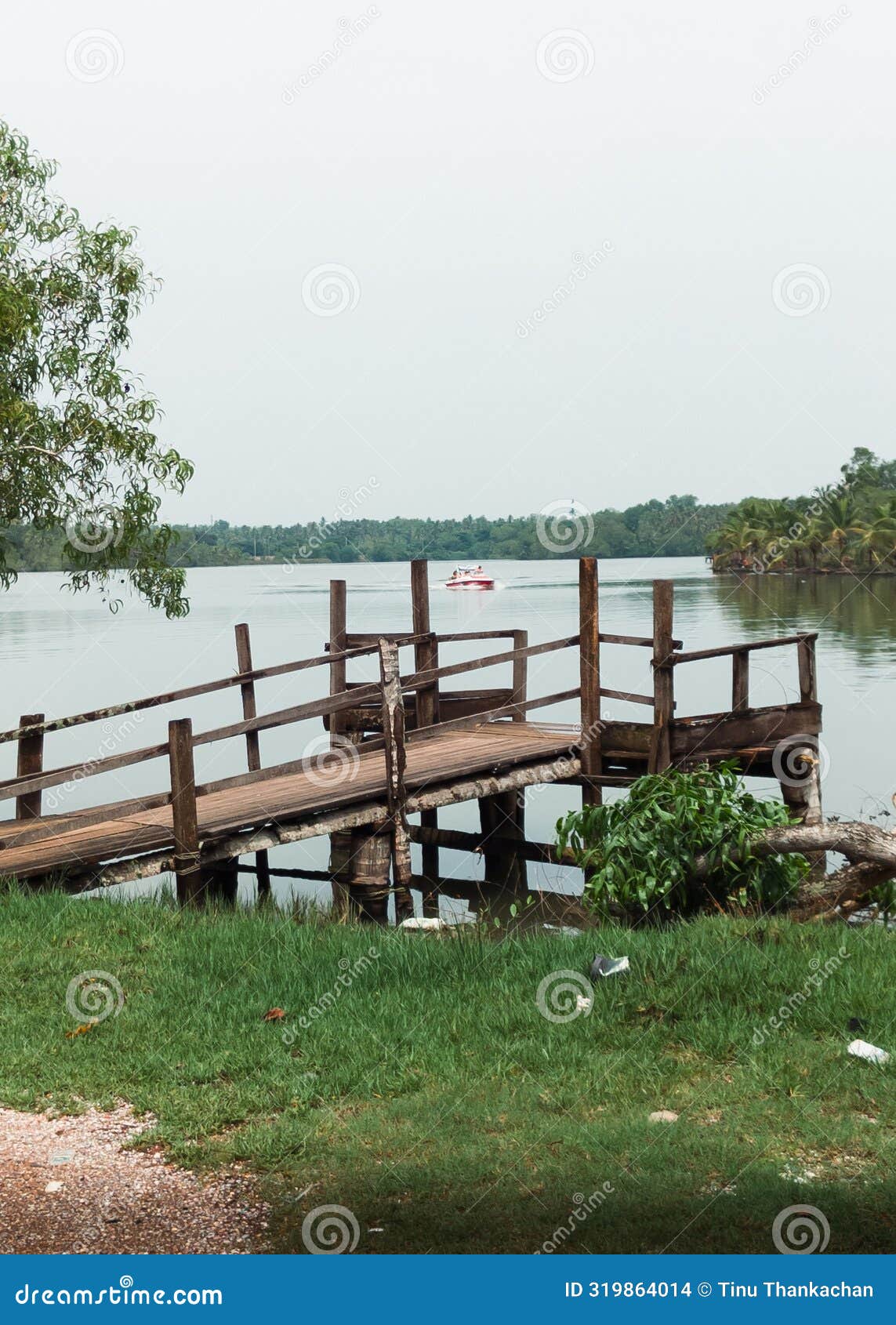 The Image Shows a Wooden Dock Extending Over a Body of Water. the ...
