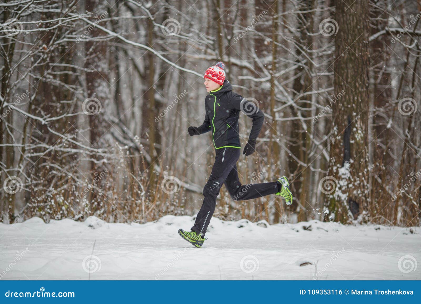 Image from Side of Man in Sportswear, Red Cap on Run in Winter Stock ...