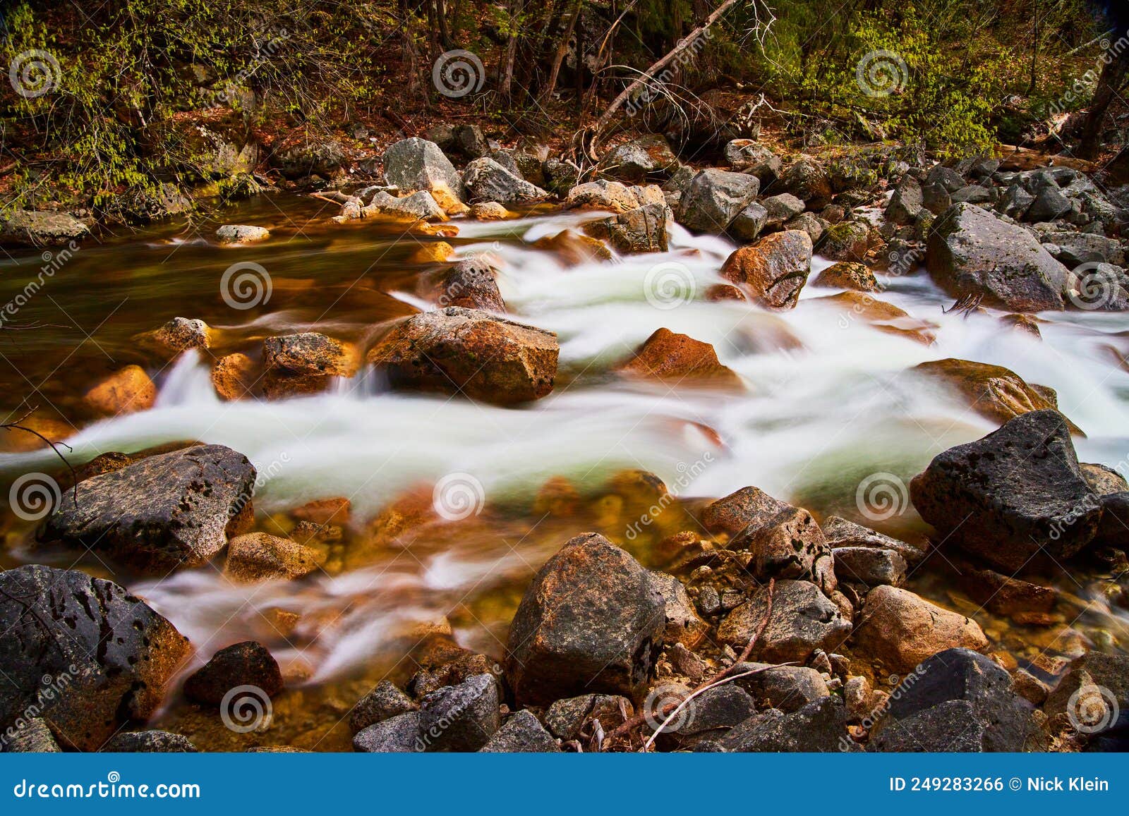 Side Profile of River with Water Cascading Over Rocks Stock Photo ...