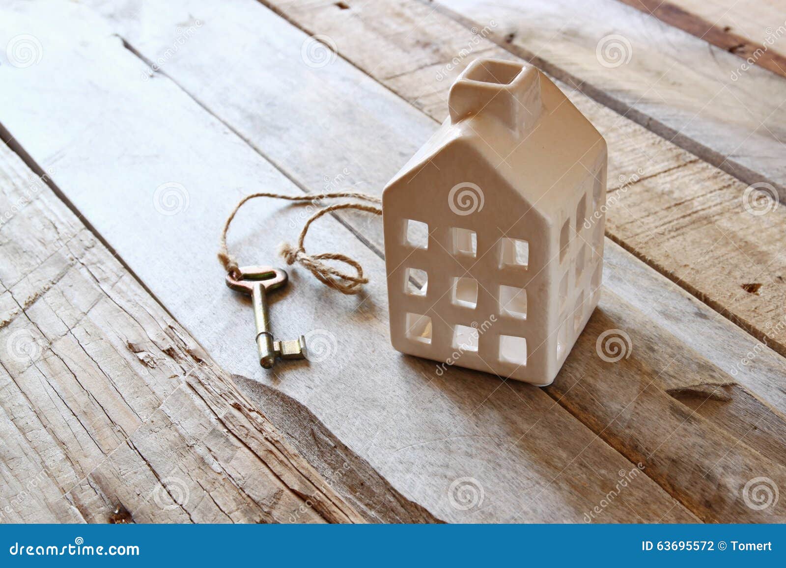 Image of Small Miniature House and Old Key Over Rustic Wooden Table ...
