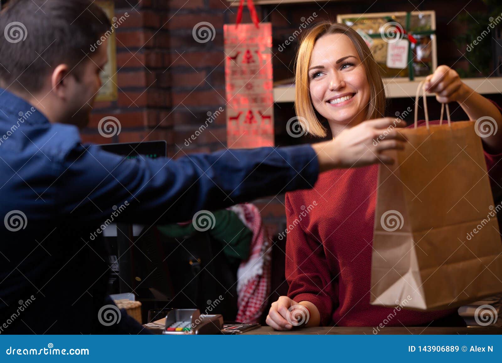 Image of Smiling Seller Woman Giving Paper Bag To Male Buyer Stock ... Image of Smiling Seller Woman Giving Paper Bag To Male Buyer Stock ...