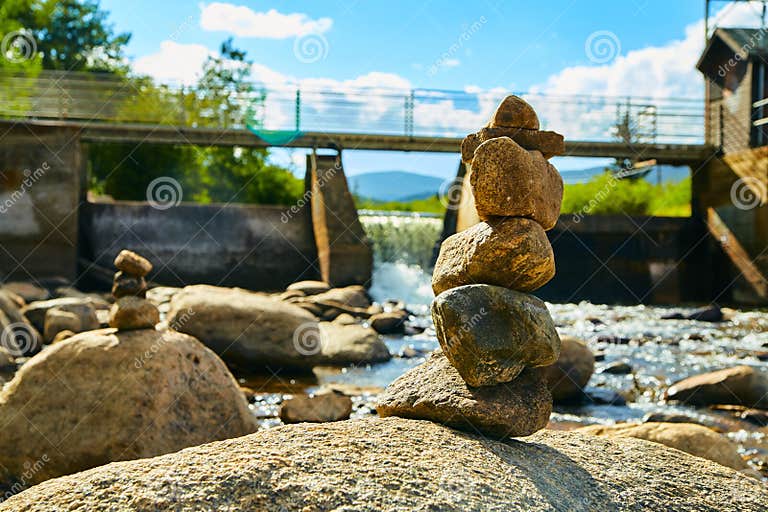 Stack of Cairn Stones with Background of Dam River and Walkway Stock ...