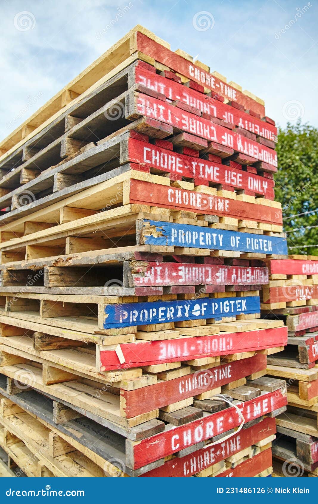 Stack of Multicolored Red and Blue and White Pallets in Front of a ...