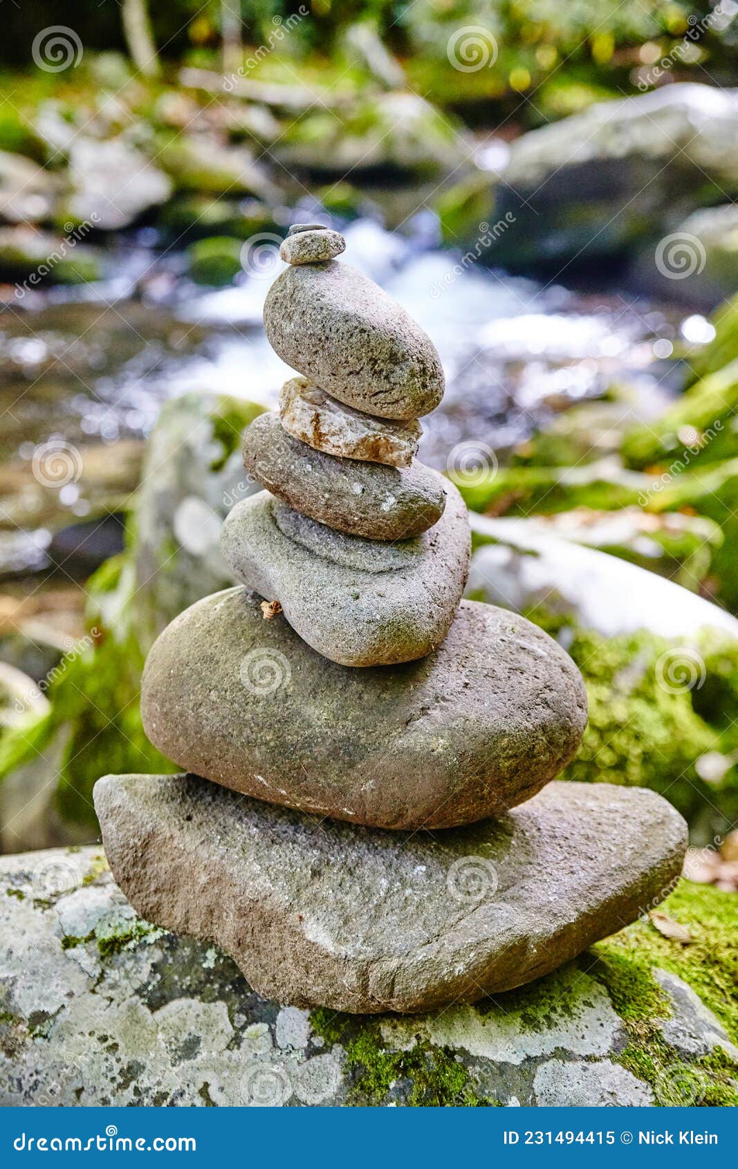 Stack of Smooth Rocks with a River in the Background Stock Image ...