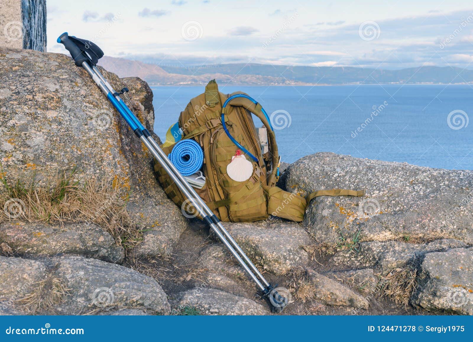 Tourist Backpack with Walking Sticks on the Rock Stock Photo - Image of ...
