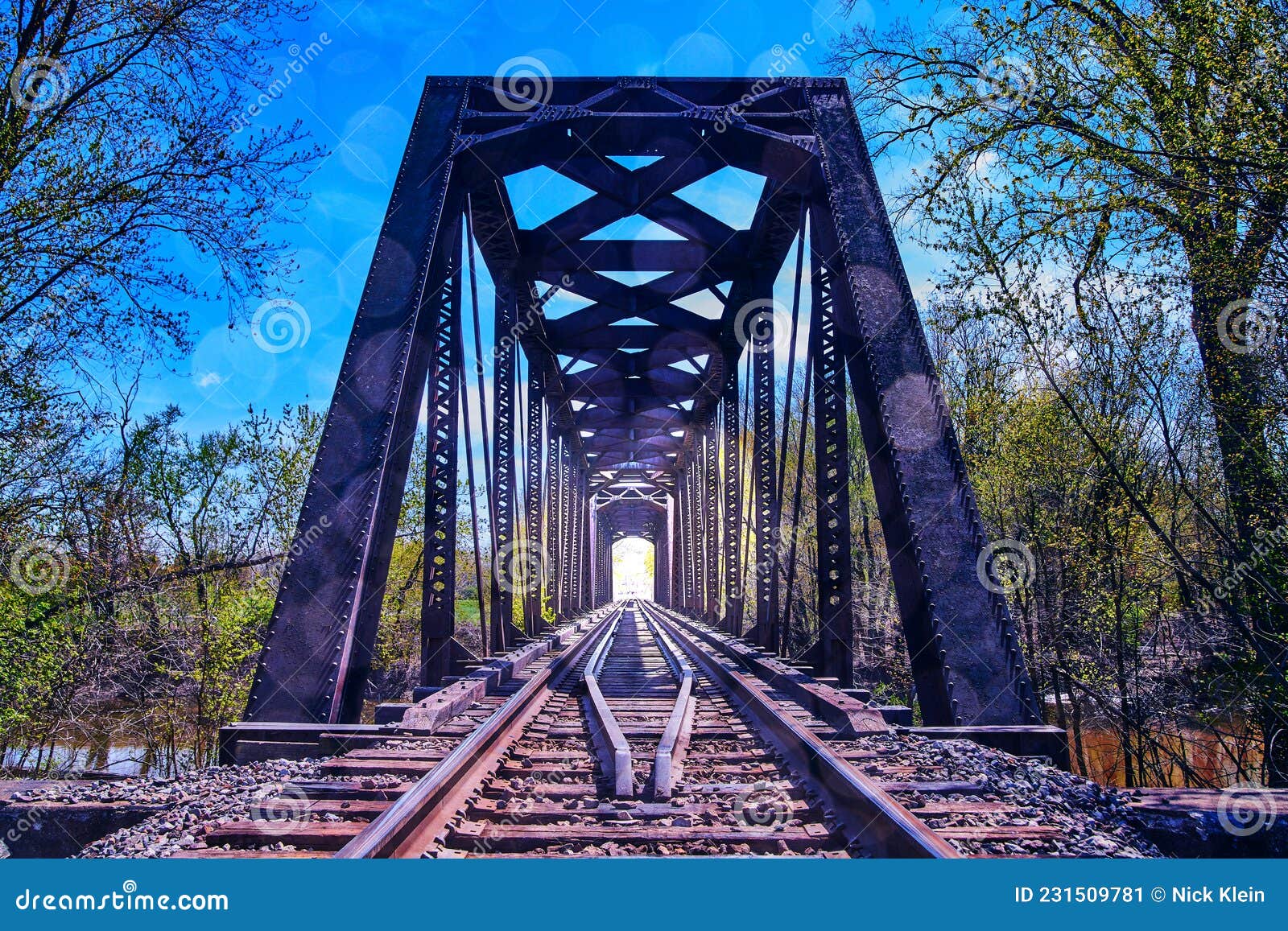 Train Tracks through Old Bridge with Bright Light at the End Stock ...