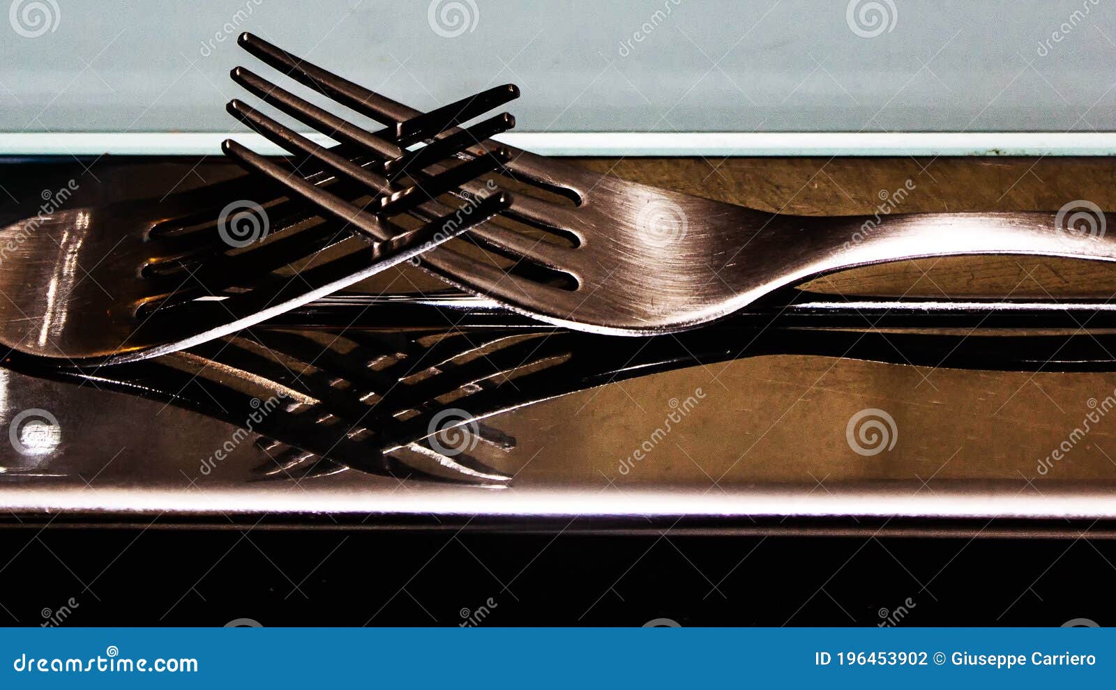 The Image of Two Crossed Forks Taken Up Close in Ferrous Material ...