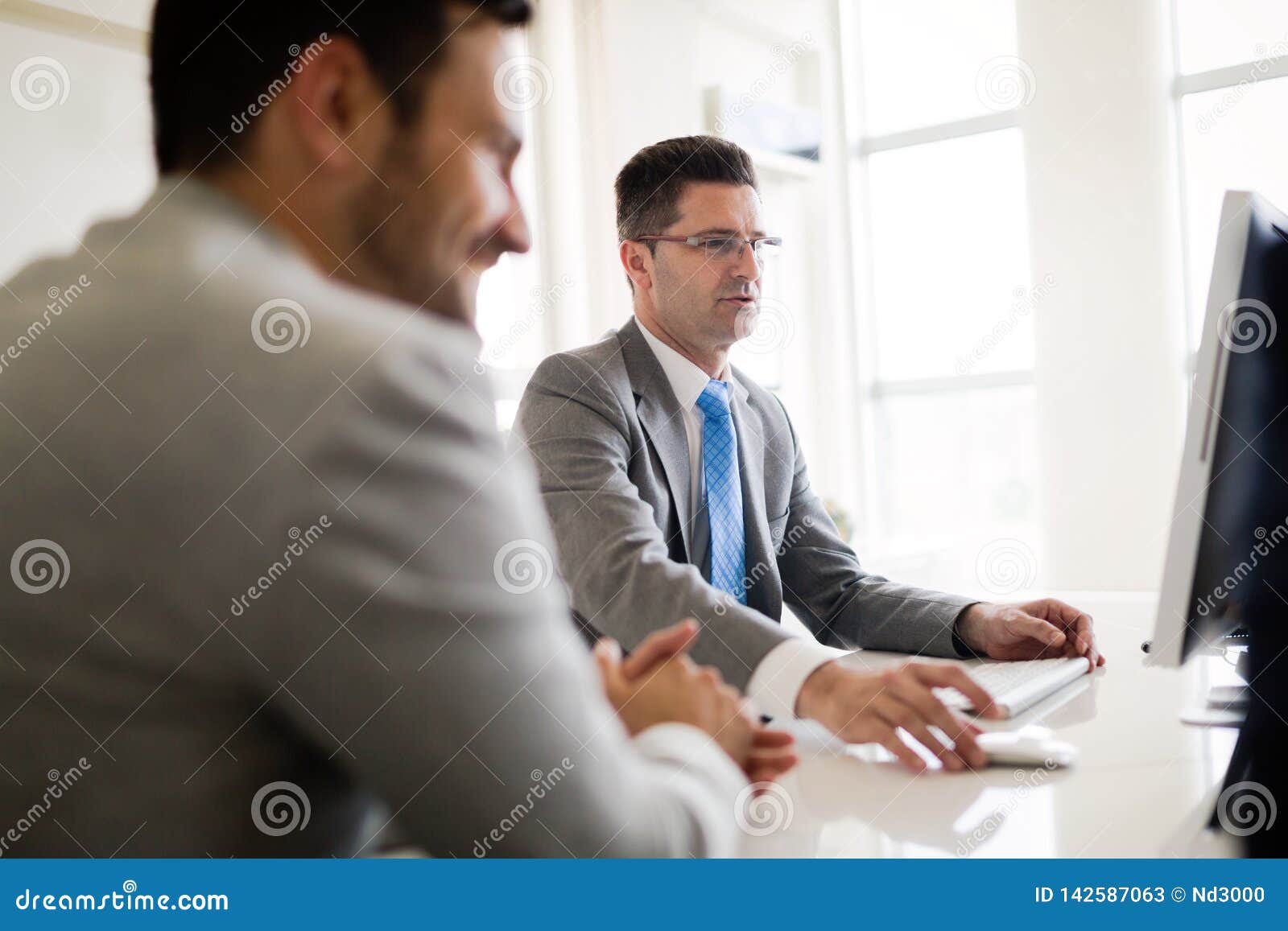 Image of Two Handsome Businessmen Using Computer at Meeting Stock Image ...