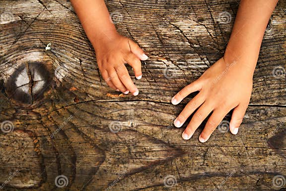 Two small hands on a table stock image. Image of concept - 121968449