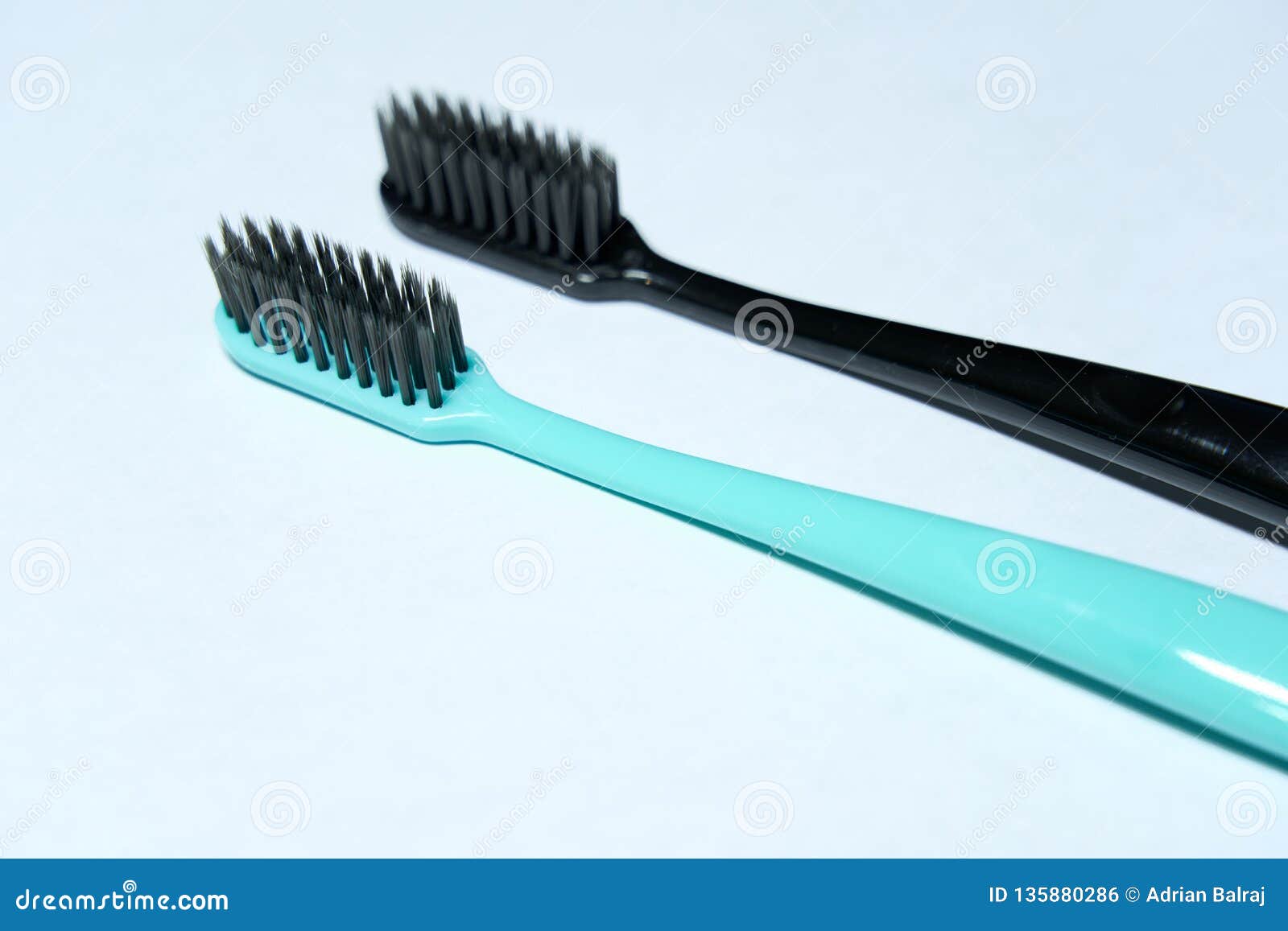 Image of Two Toothbrushes Against Solid Background Stock Photo - Image ...