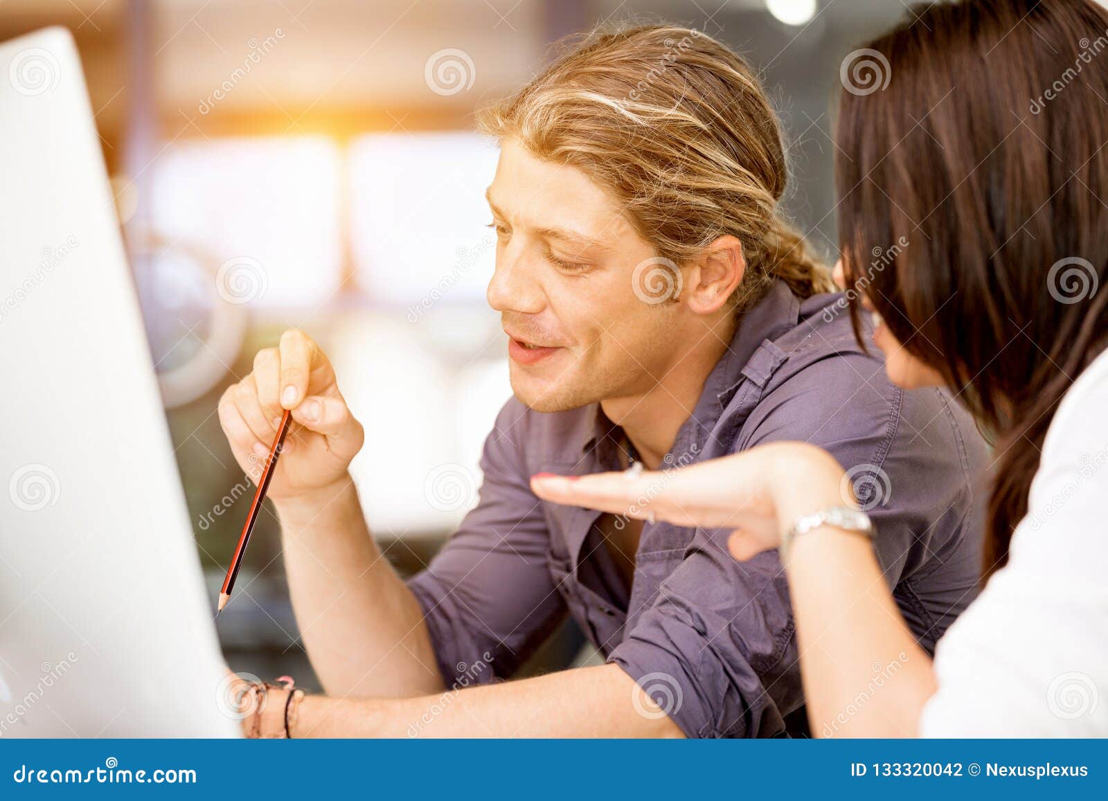 Image of Two Young Business People in Office Stock Photo - Image of ...