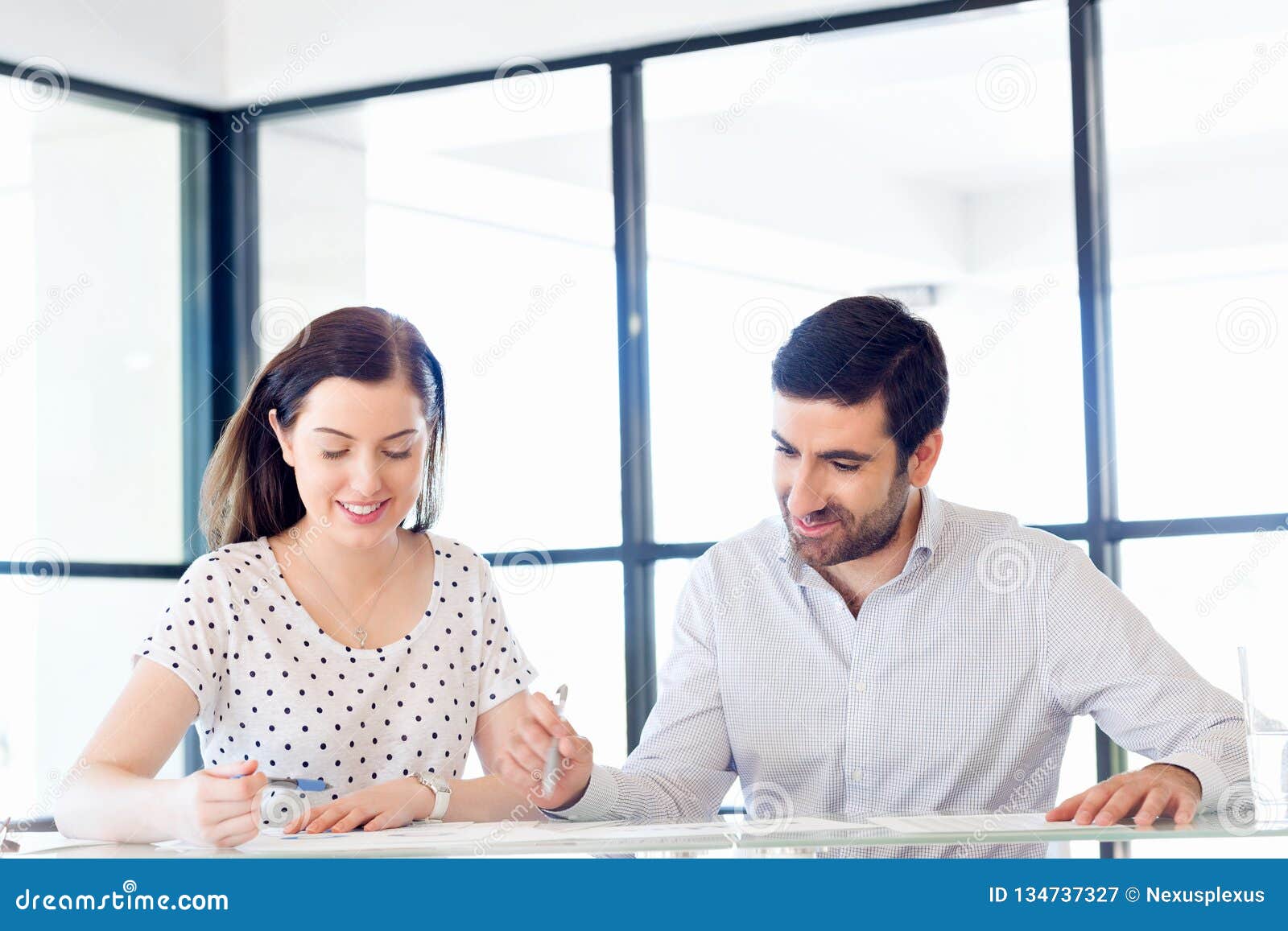 Image of Two Young Business People in Office Stock Image - Image of ...