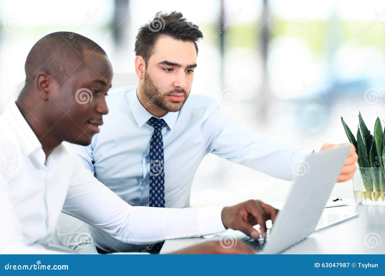 Image of Two Young Businessmen Stock Image - Image of discussing ...