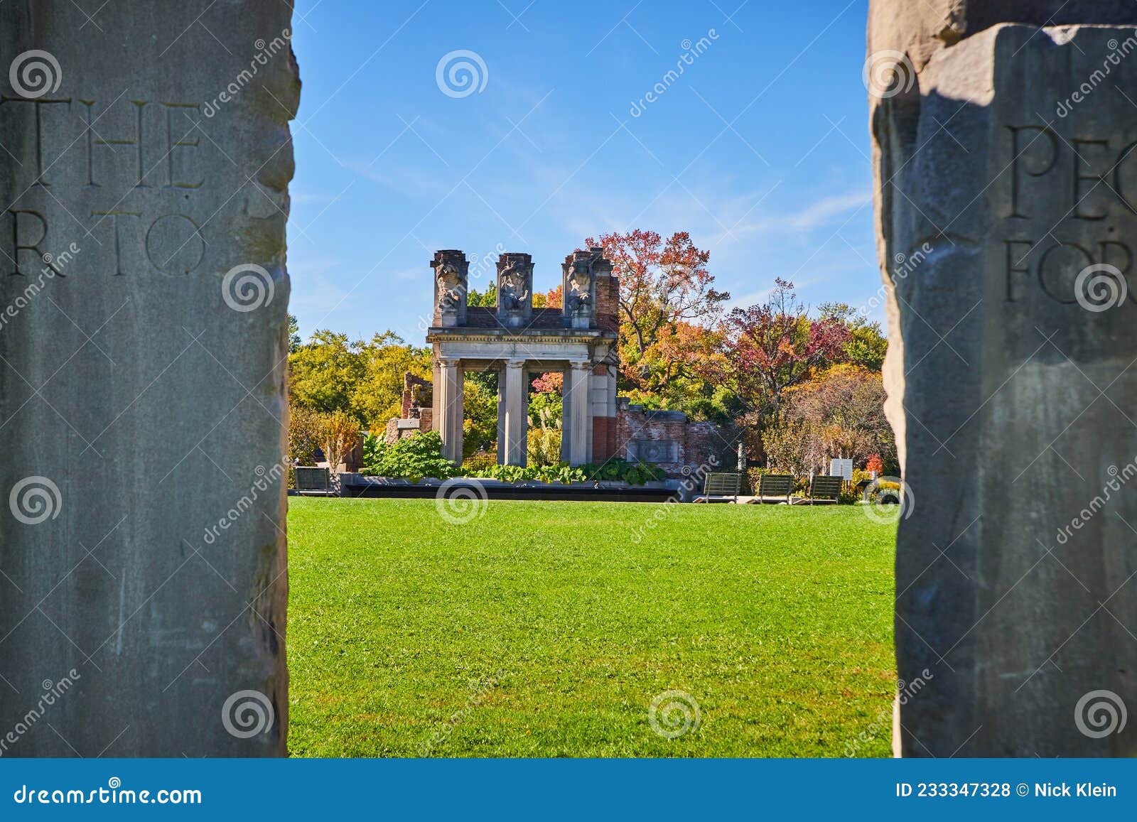 View through Two Stone Obelisks of Old Stone and Brick Ruins in Park ...
