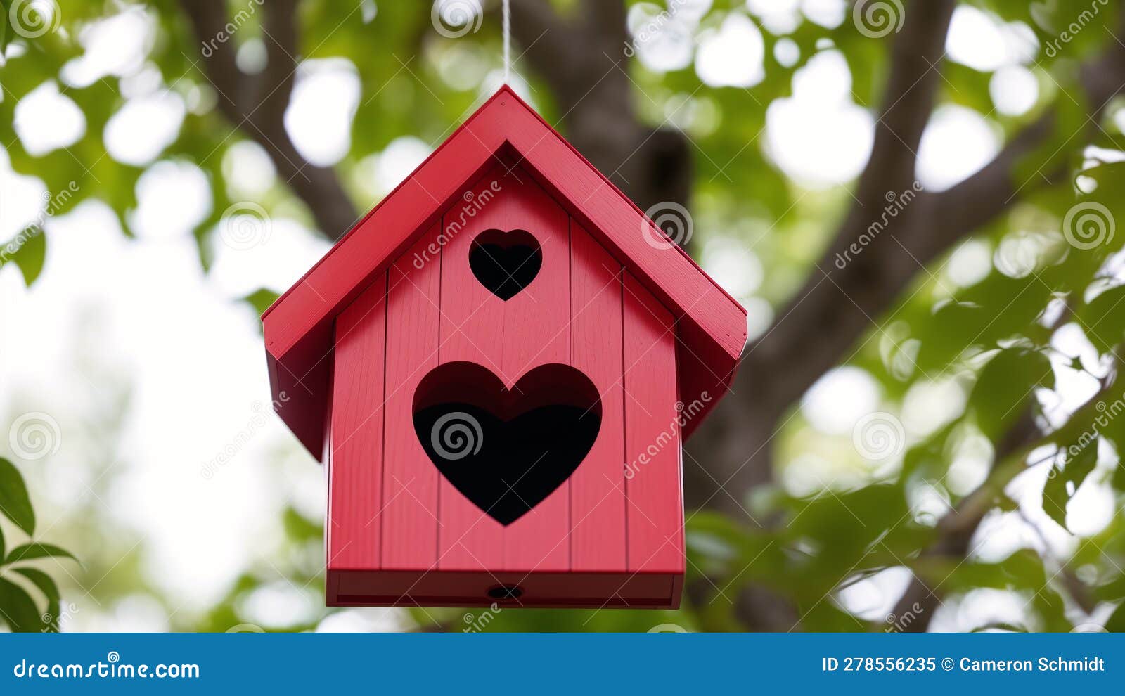 An Image of a Visually Stimulatingly Painted Birdhouse Hanging from a ...