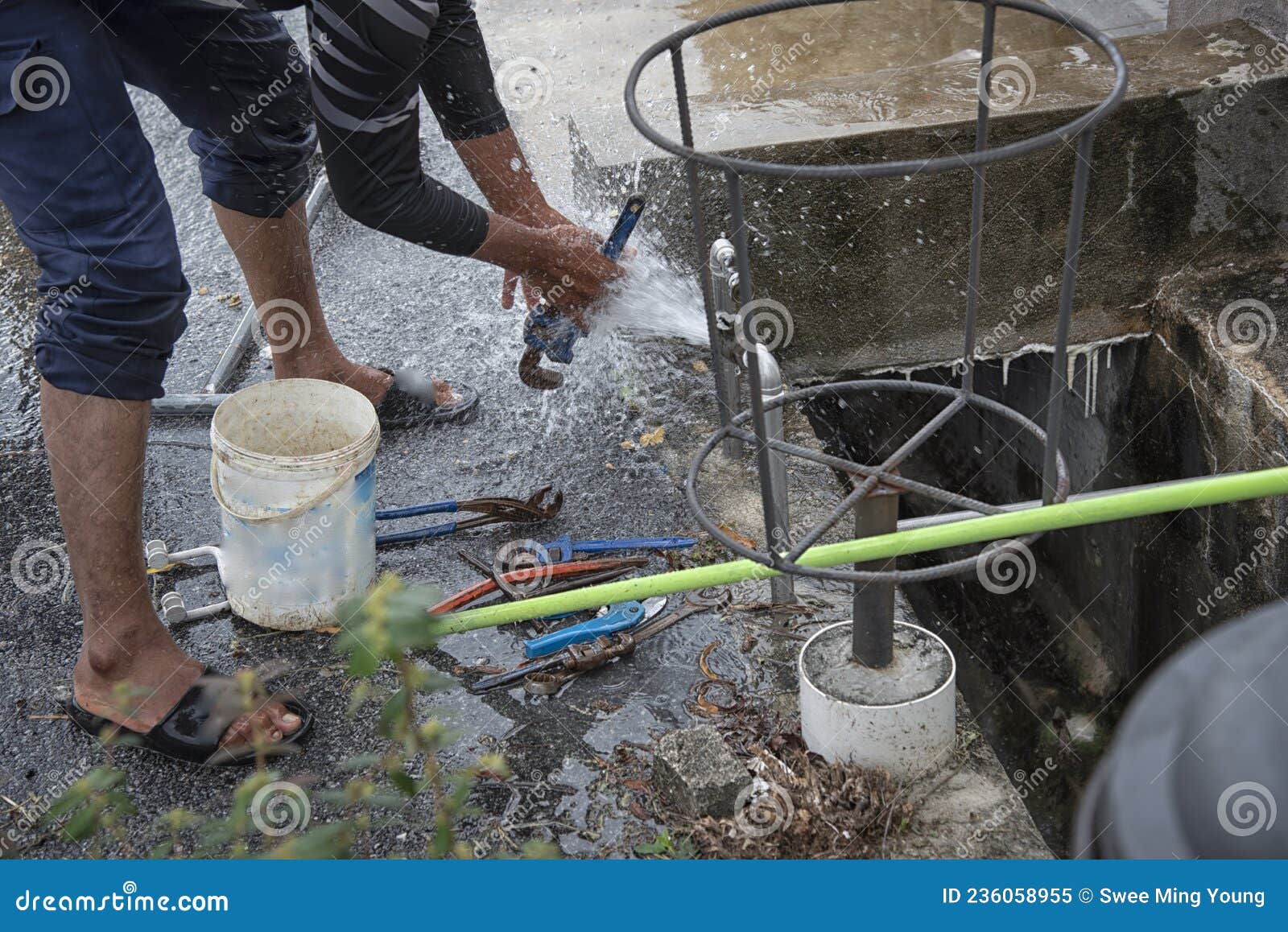 Washing Hand,legs and Plumbing Tools with the Burst Water Pipe ...