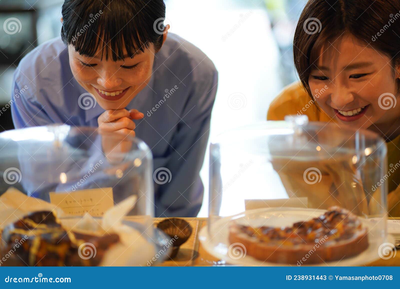 Female choosing a cake stock image. Image of eating - 238931443