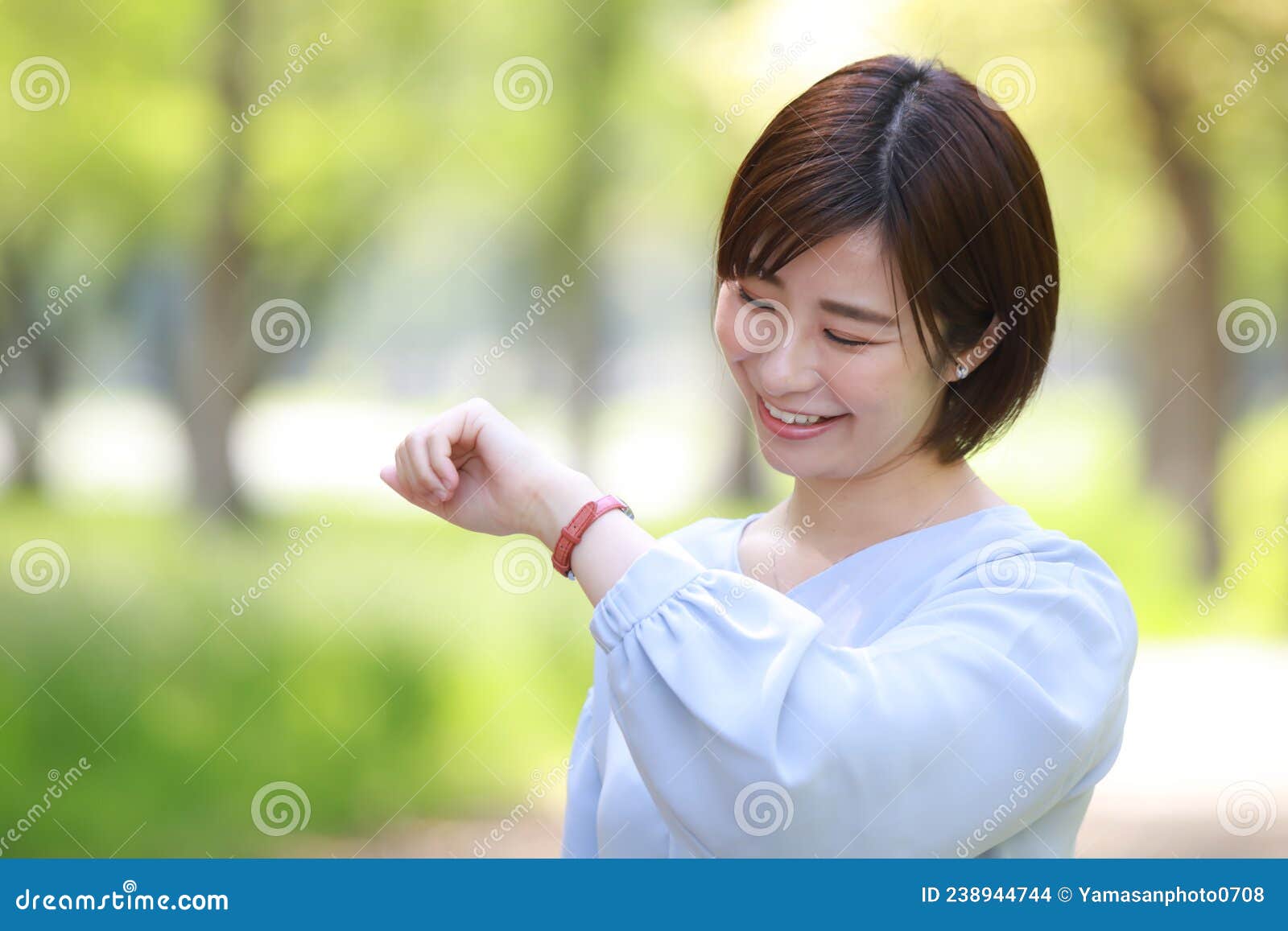 Woman looking at a watch stock photo. Image of female - 238944744