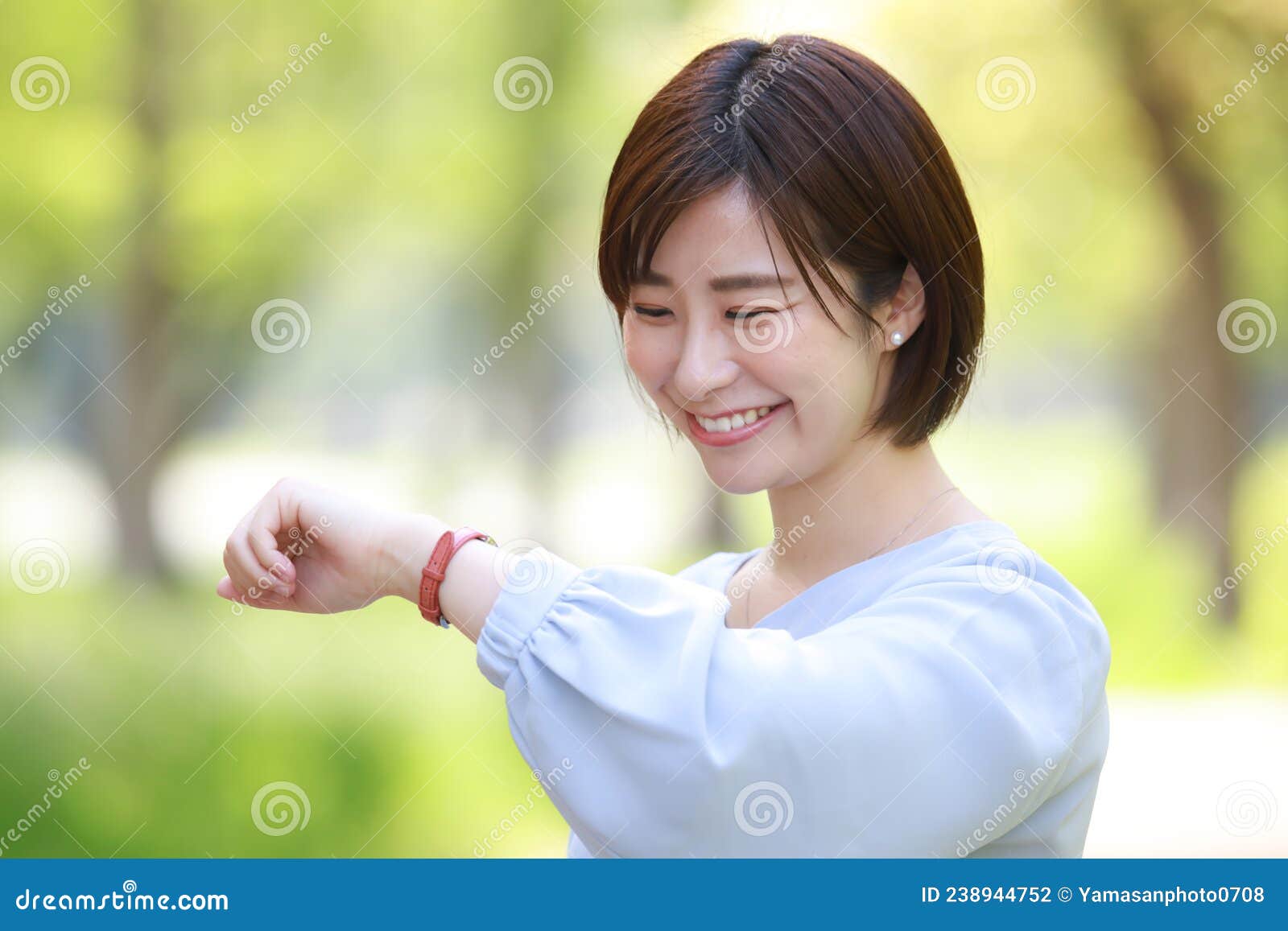 Woman looking at a watch stock photo. Image of business - 238944752