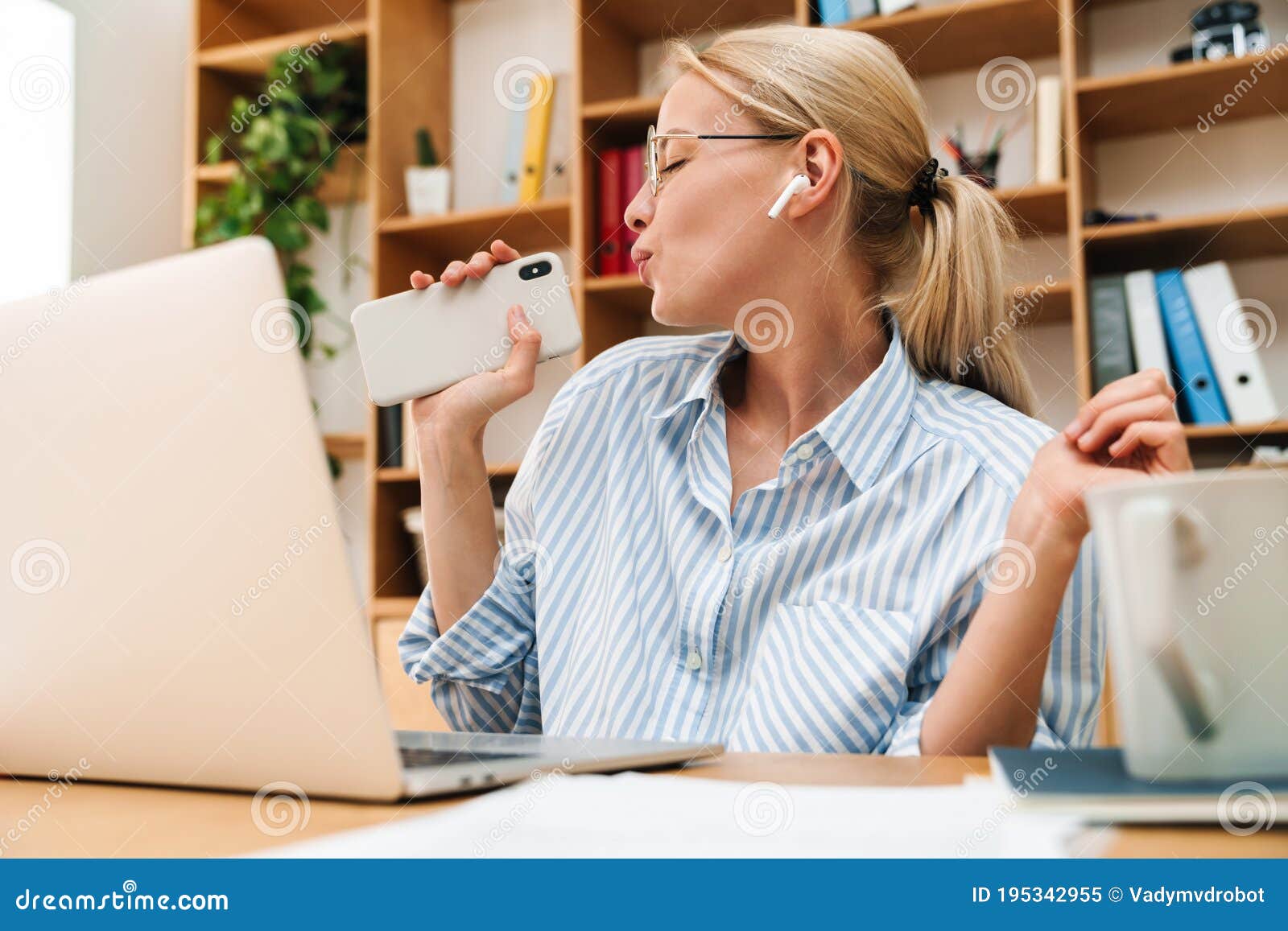 Image of Woman Using Earphones and Singing while Working with Laptop ...