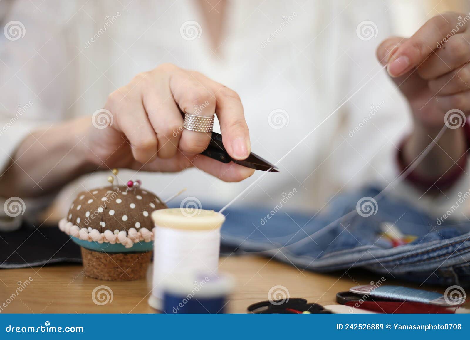 Woman cutting the thread stock image. Image of food - 242526889