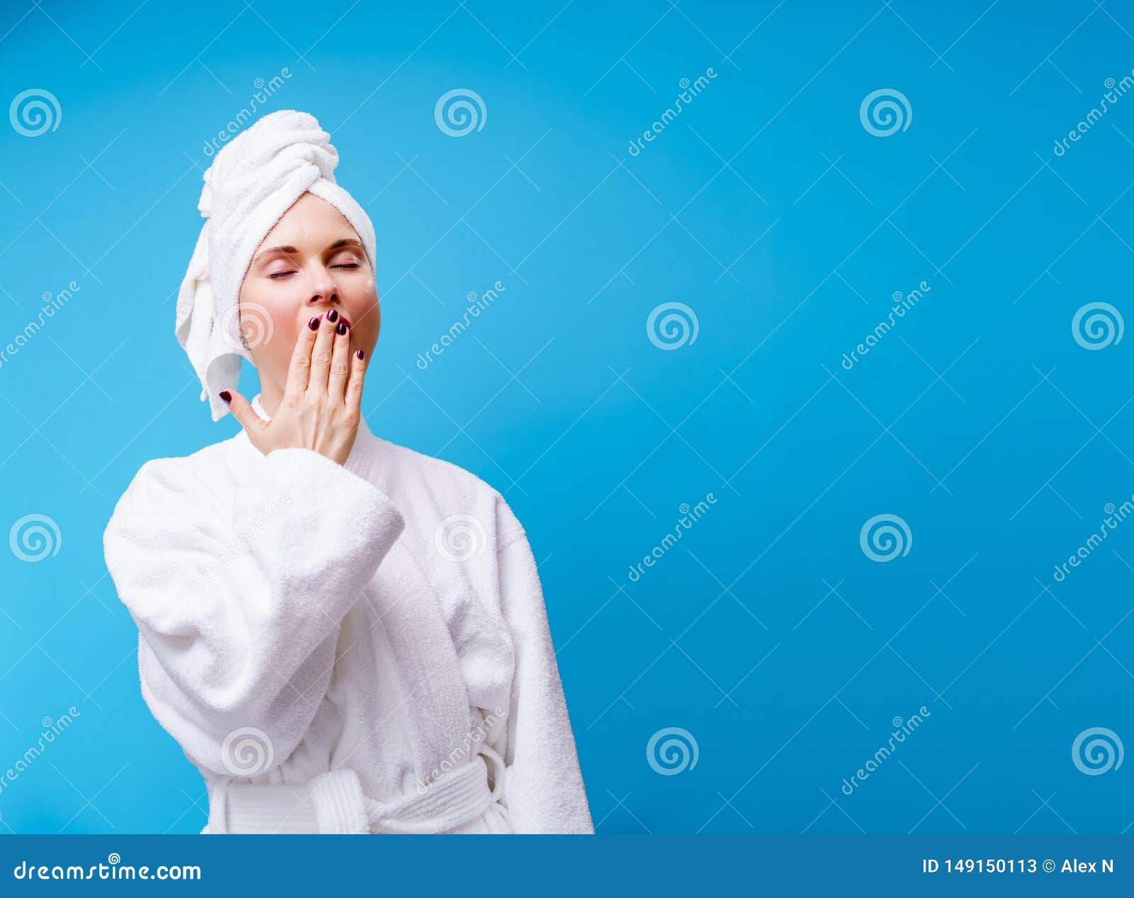 Image of Yawning Girl in White Coat and Towel on Head Stock Image ...