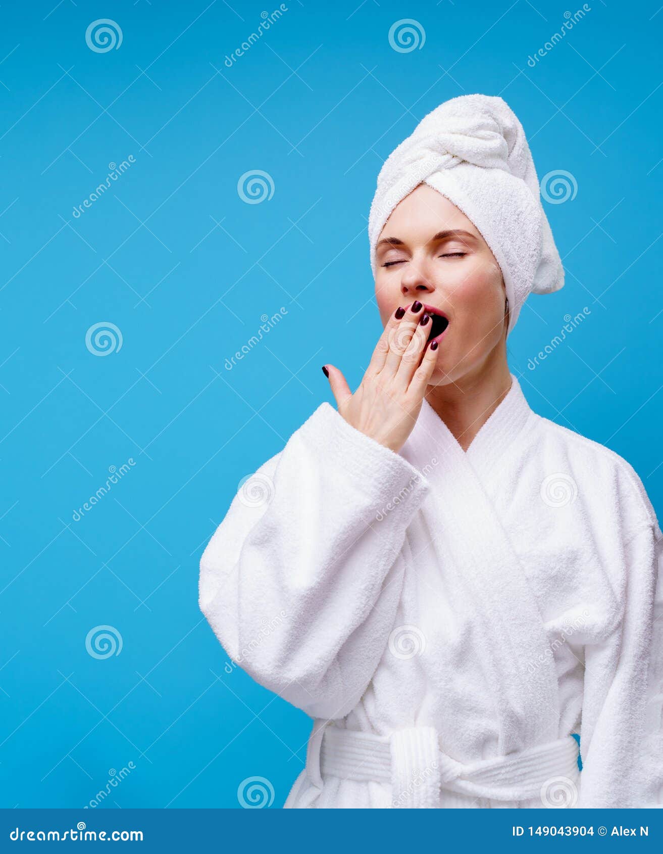 Image of Yawning Woman in White Coat and Towel on Head Stock Photo ...