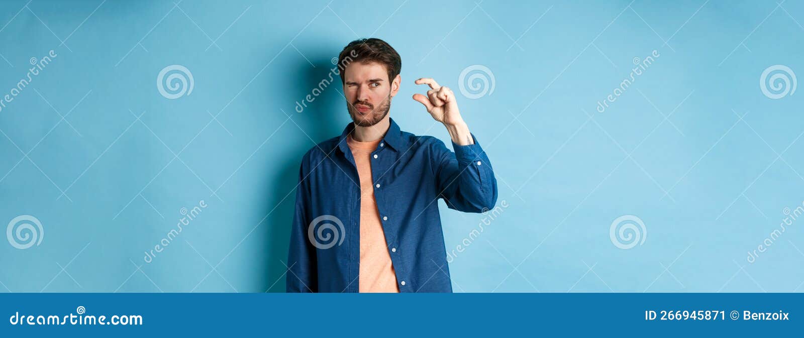 Image of Young Caucasian Man Showing Small Size and Squinting To See ...