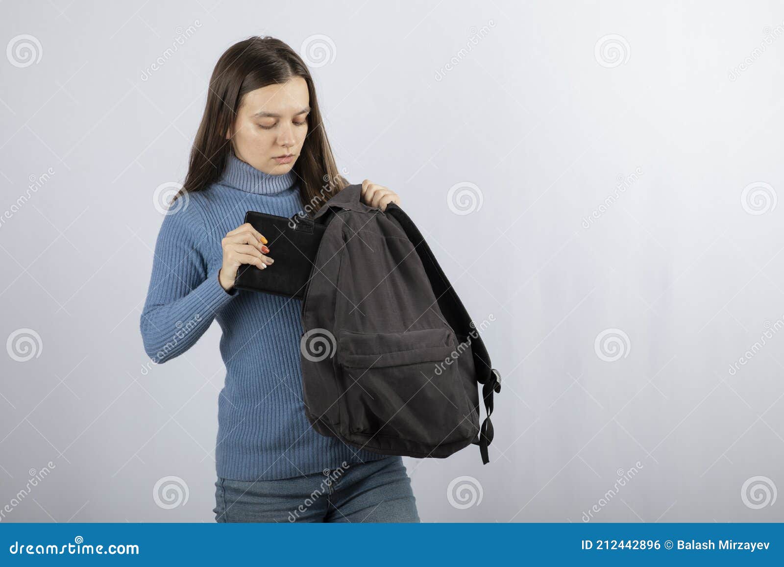 Image of a Young Girl Student Putting Notebook in Backpack Stock Photo ...