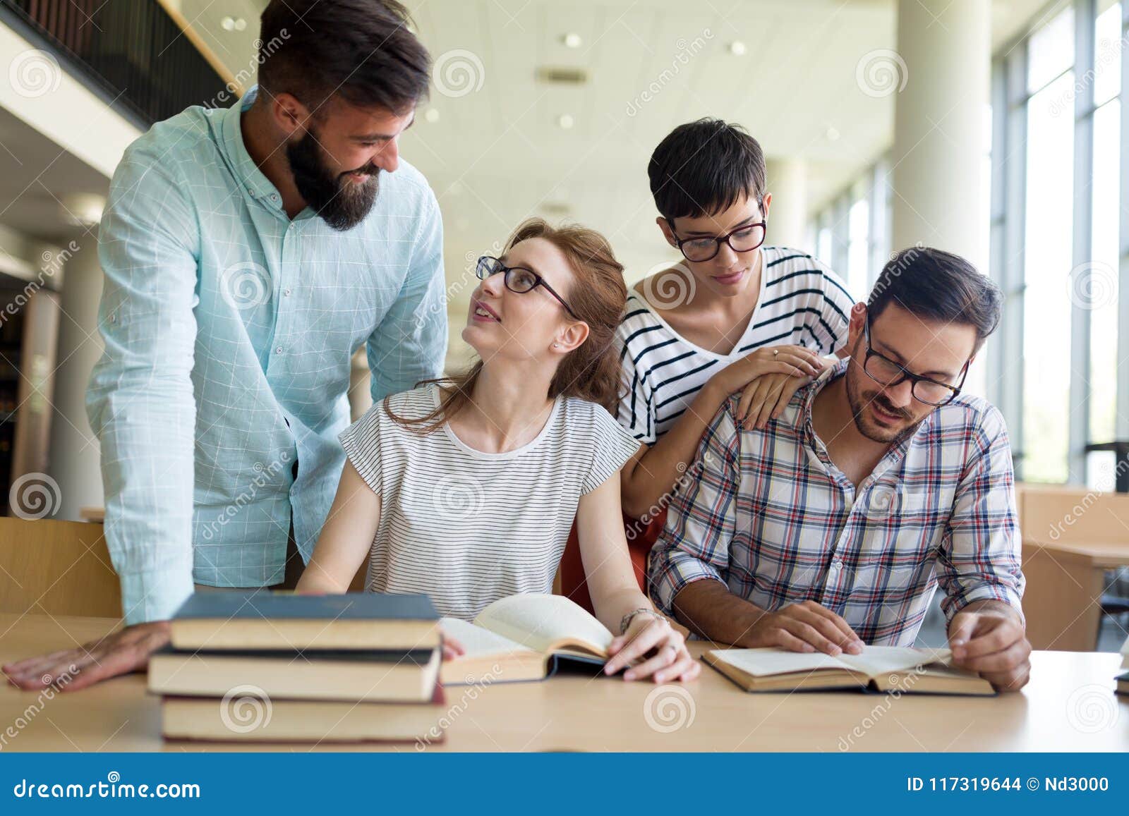 Young Happy Students Sitting in Library Stock Photo - Image of female ...