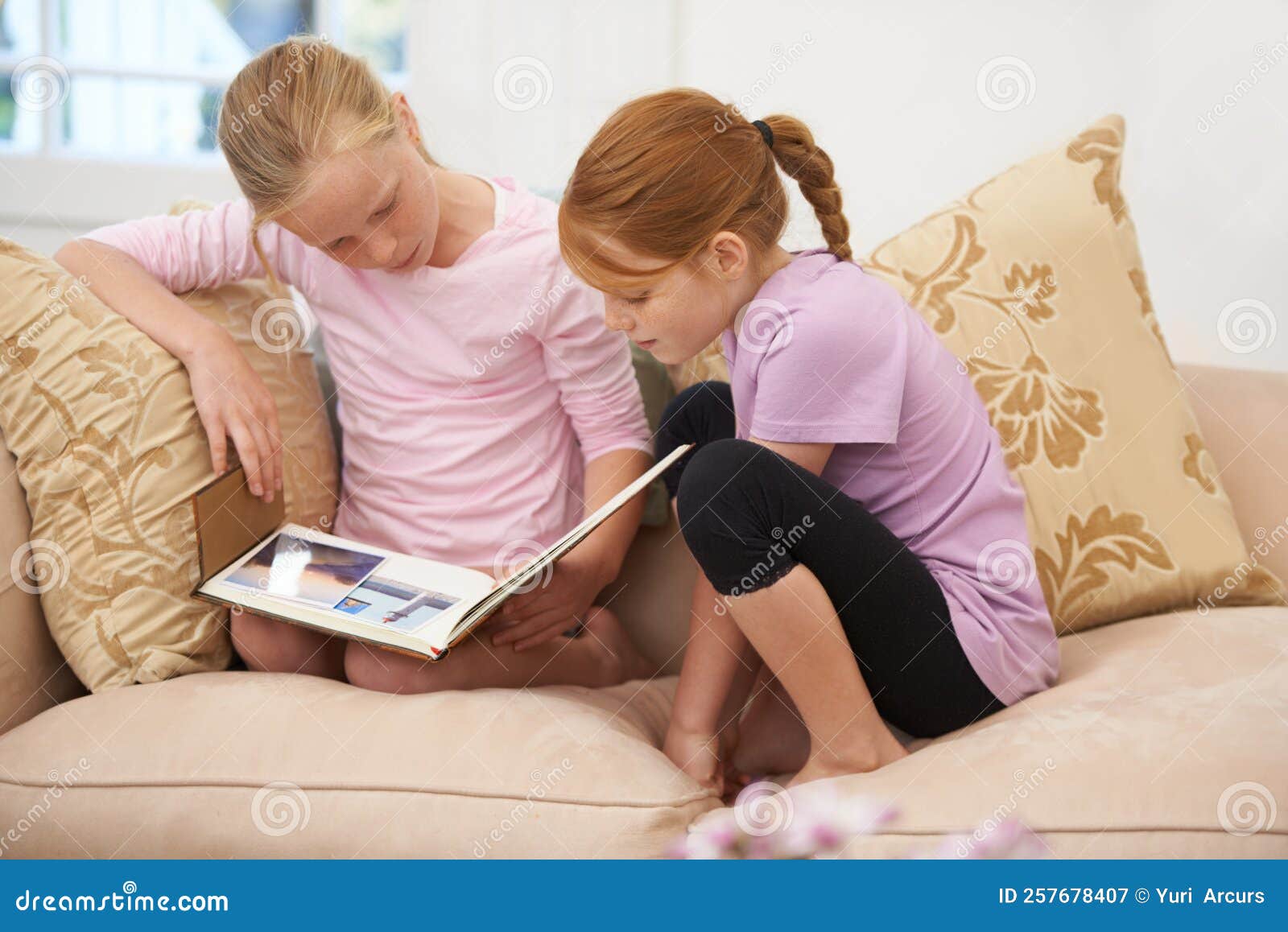 Imagination Time. Two Sisters Reading a Storybook in the Lounge. Stock ...