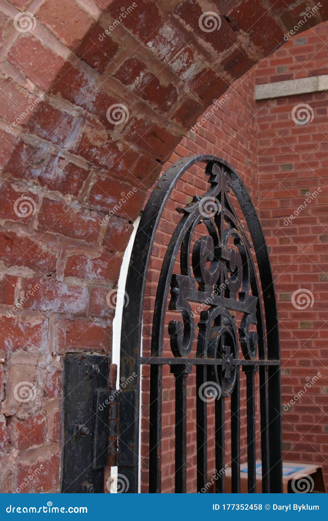 A Metal Gate Guards the Entry To a Brick Courtyard Stock Photo - Image ...
