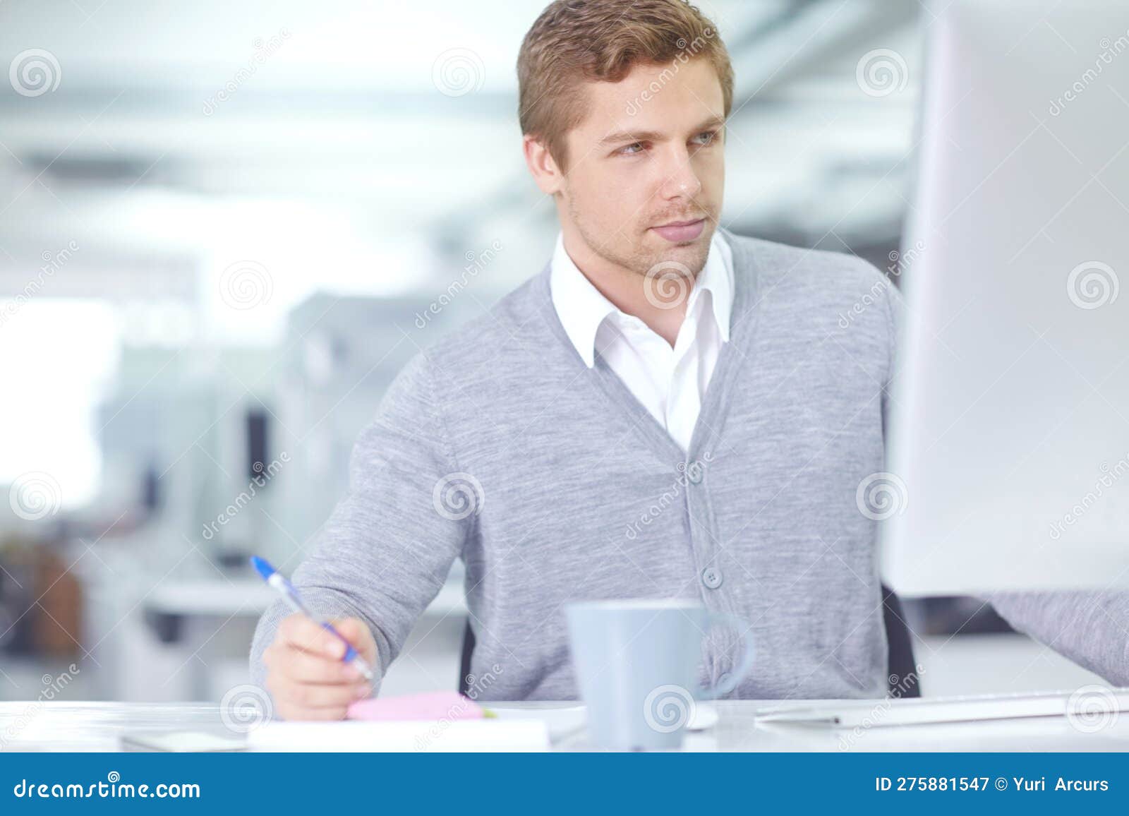 Immersed in His Work. a Handsome Young Office Worker Sitting at His ...