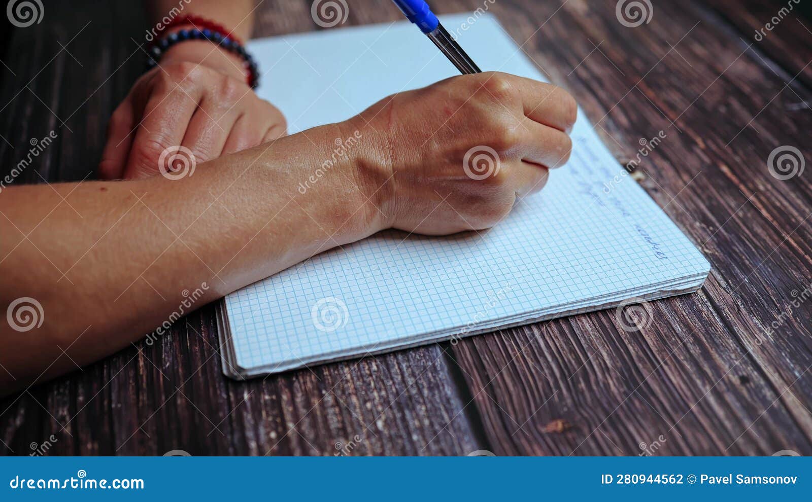 The Student is Doing Her Homework, Writing Notes in a Notebook. on the ...