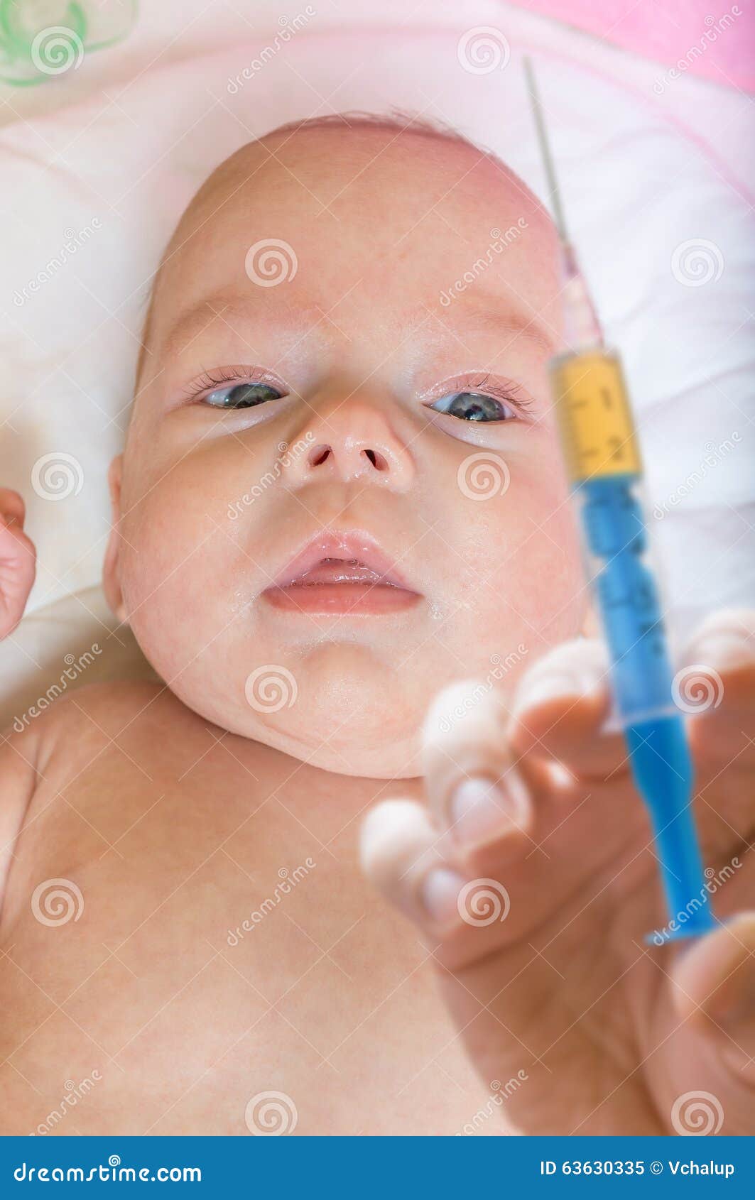 Immunization Concept - Baby Starring On Syringe With Vaccine For ...