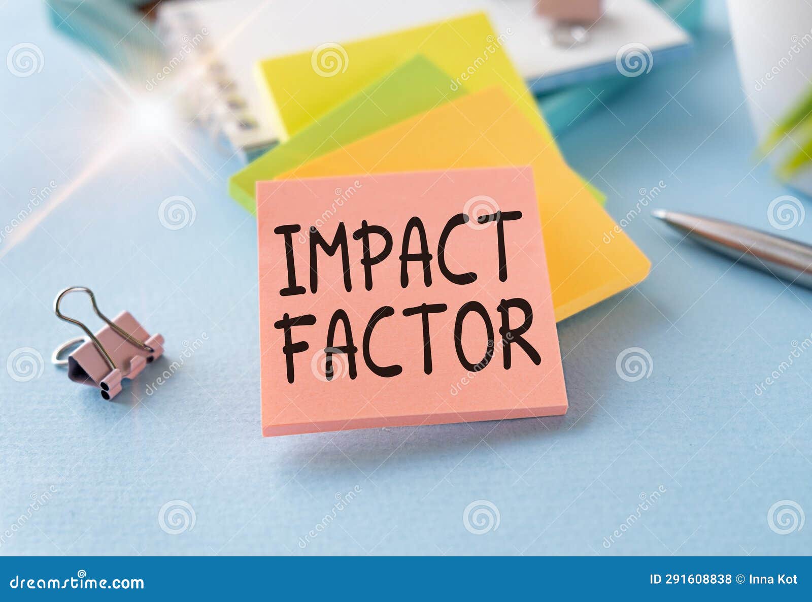 Impact Factor Text on Sticker with Pen and Paper Clip on Blue Table ...