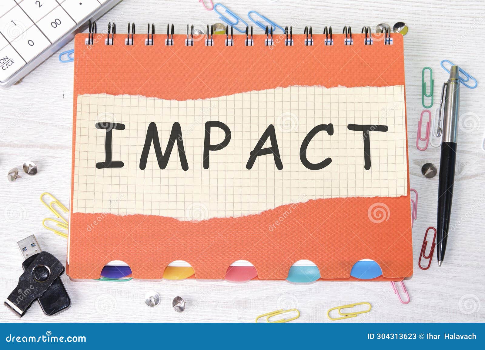 IMPACT Word is Written on a Sheet in a Cage Lying on a Notebook on the ...