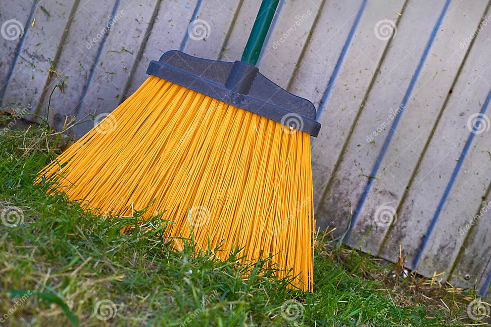 Yellow Plastic Mop Sweeping Trash in the Yard Stock Photo - Image of ...