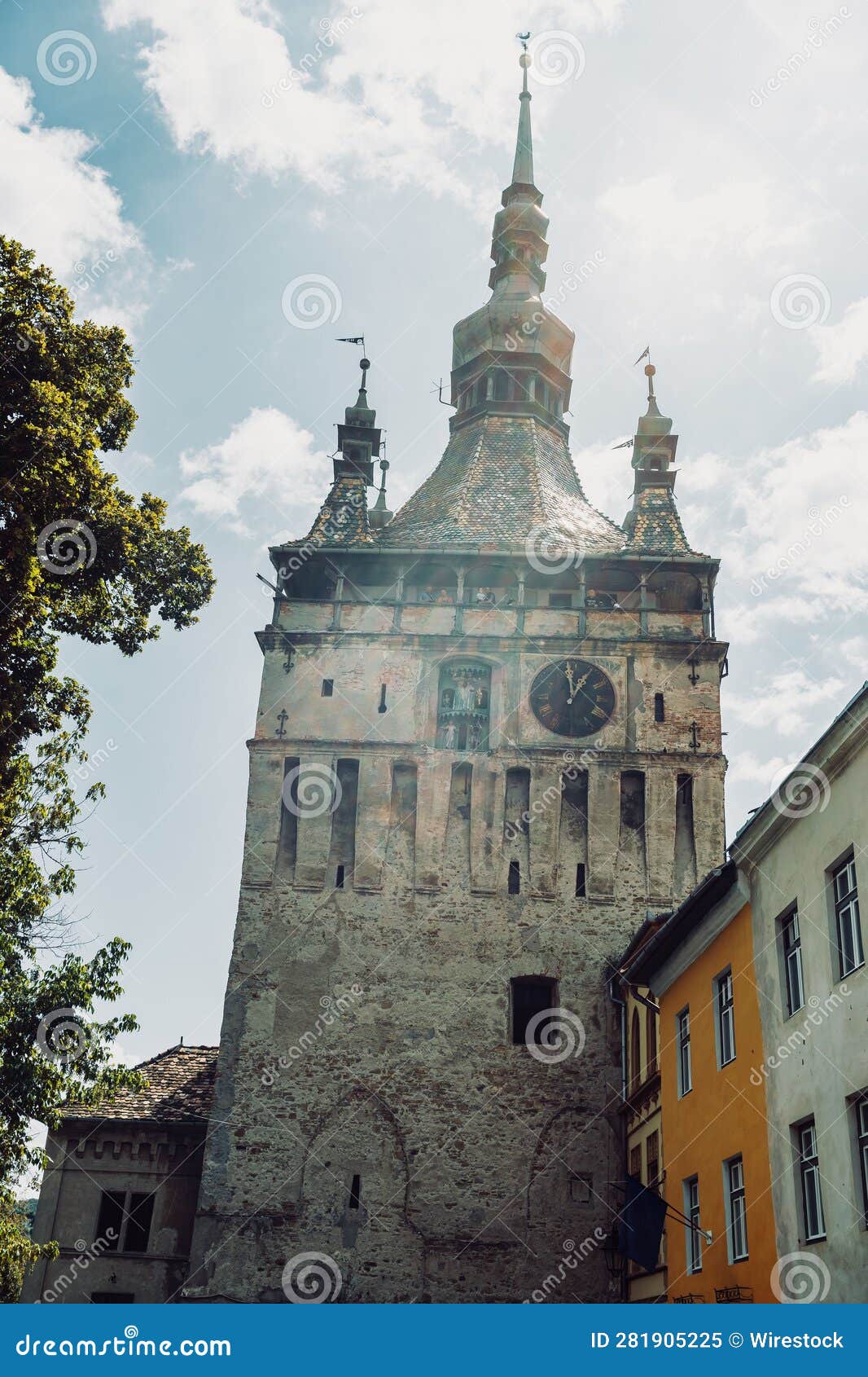 A Tall Brick Building with Several Windows and a Tower on the Side ...