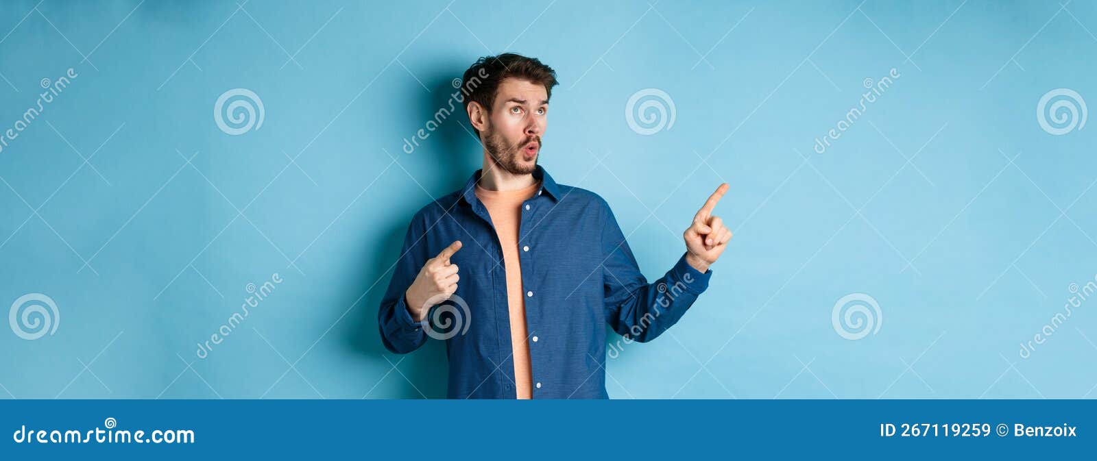 Impressed Guy Looking and Pointing at Upper Left Corner, Showing ...