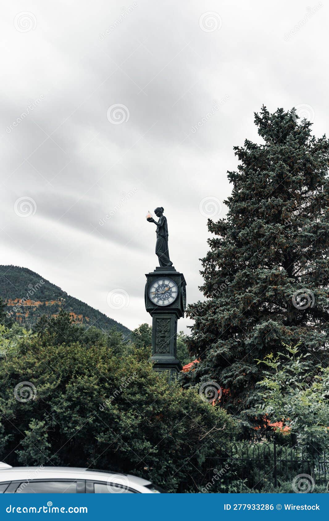Impressive Clock Tower and a Figure, Set Against a Backdrop of Majestic ...