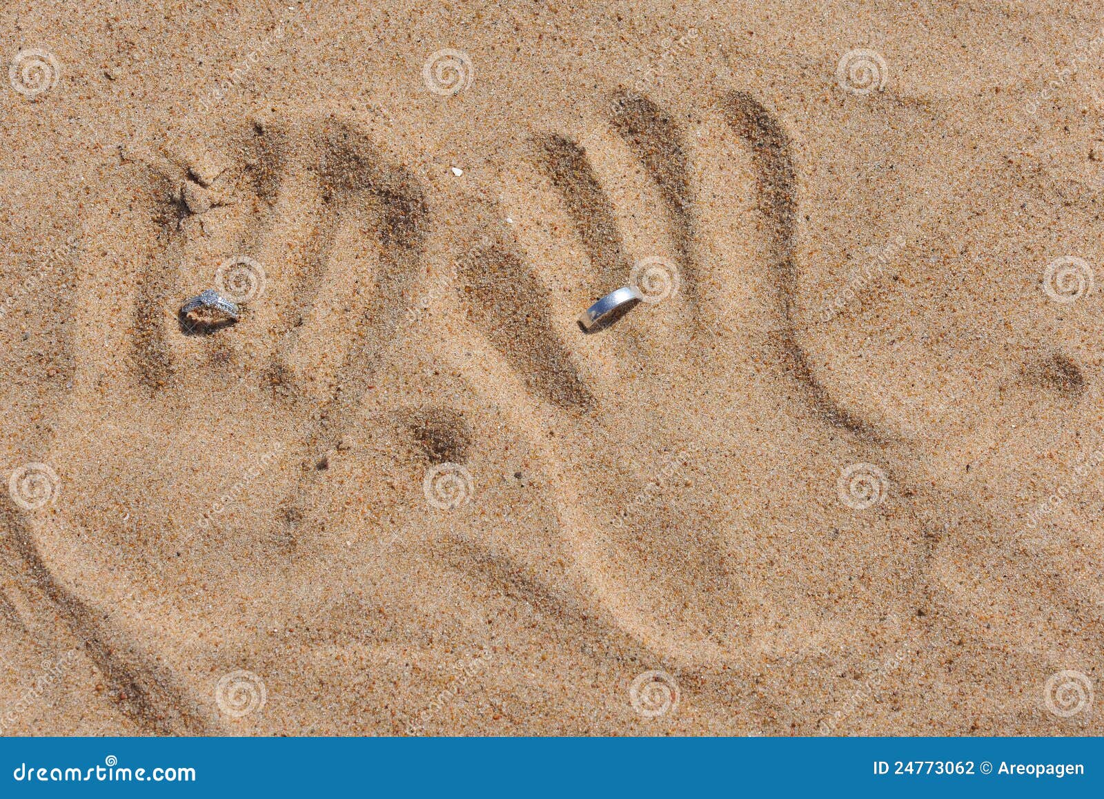 An Imprint of Hands in the Sand with Rings. Stock Photo - Image of ...