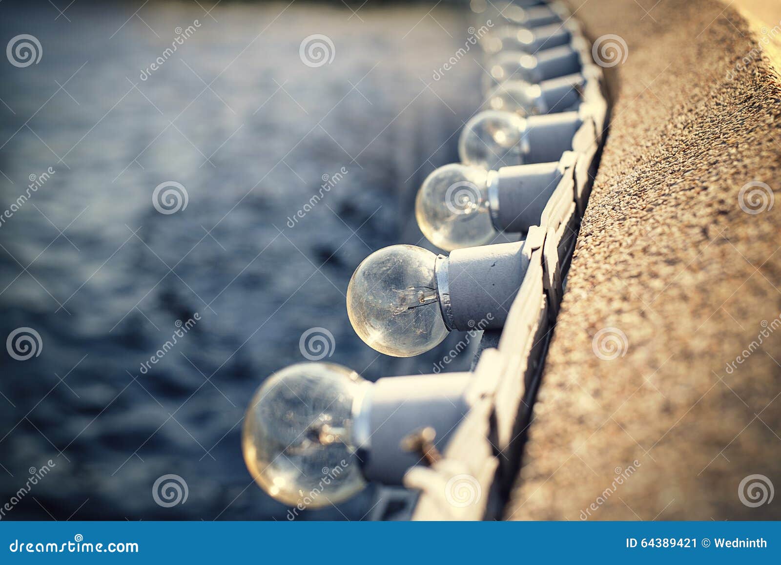 Incandescents or Light Bulbs in a Row on Wall Edge Stock Image - Image ...