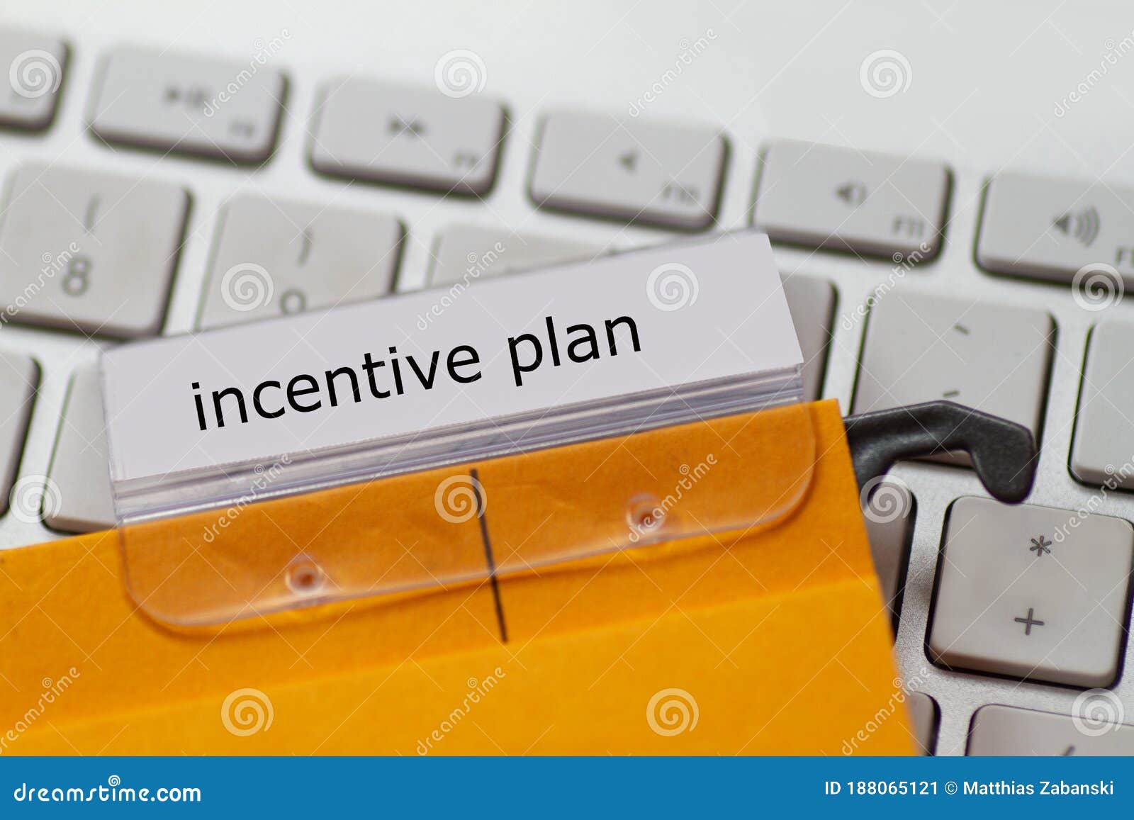 Incentive Plan As a Term on a Tab on a Yellow Hanging File on a ...