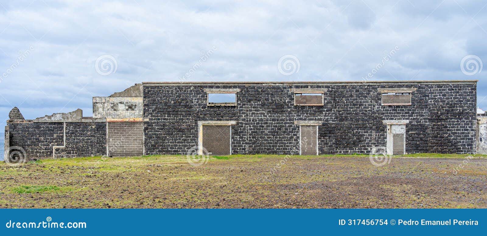 Incomplete Black Brick Wall Facade with Cemented Doors and Windows ...