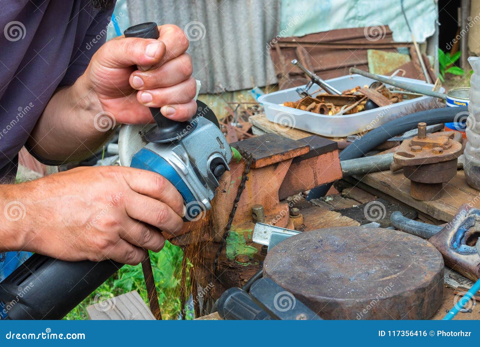 Independent Tool Making Using a Vise and Angle Grinder, Hands of a ...