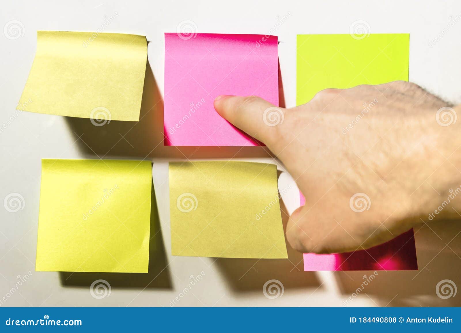 The Index Finger Points at the Colored Square Post-it Notes Pasted on ...