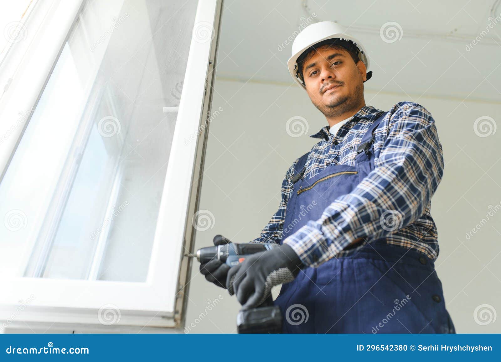 Indian Construction Worker Installing Window in House. Stock Photo ...